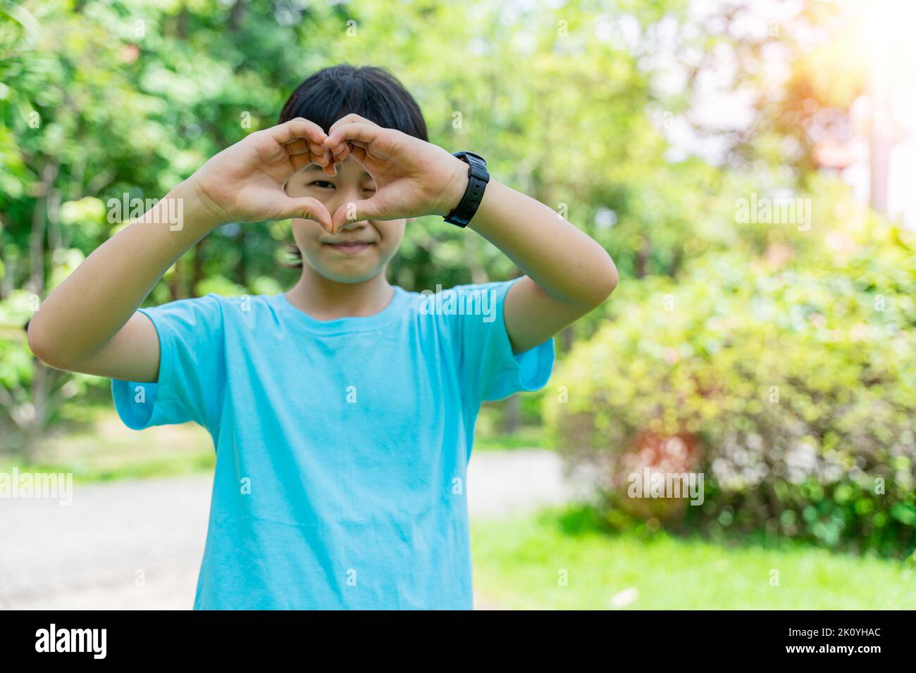 Portrait of happy child's hands gesture in heart shape showing love and ...
