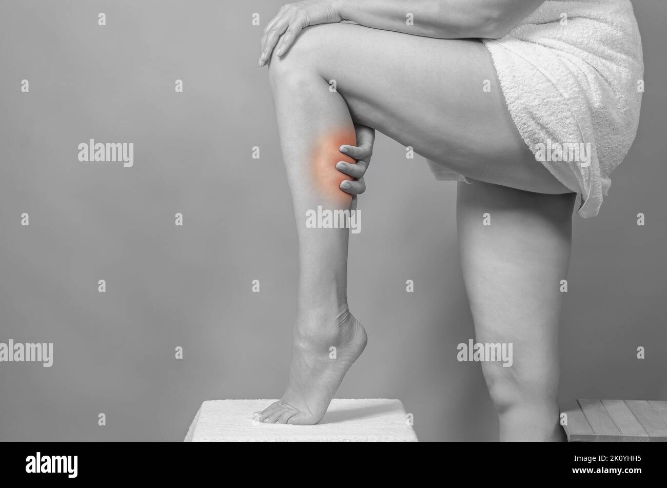 Removal of body hair. A woman touches smooth skin on her legs after ...