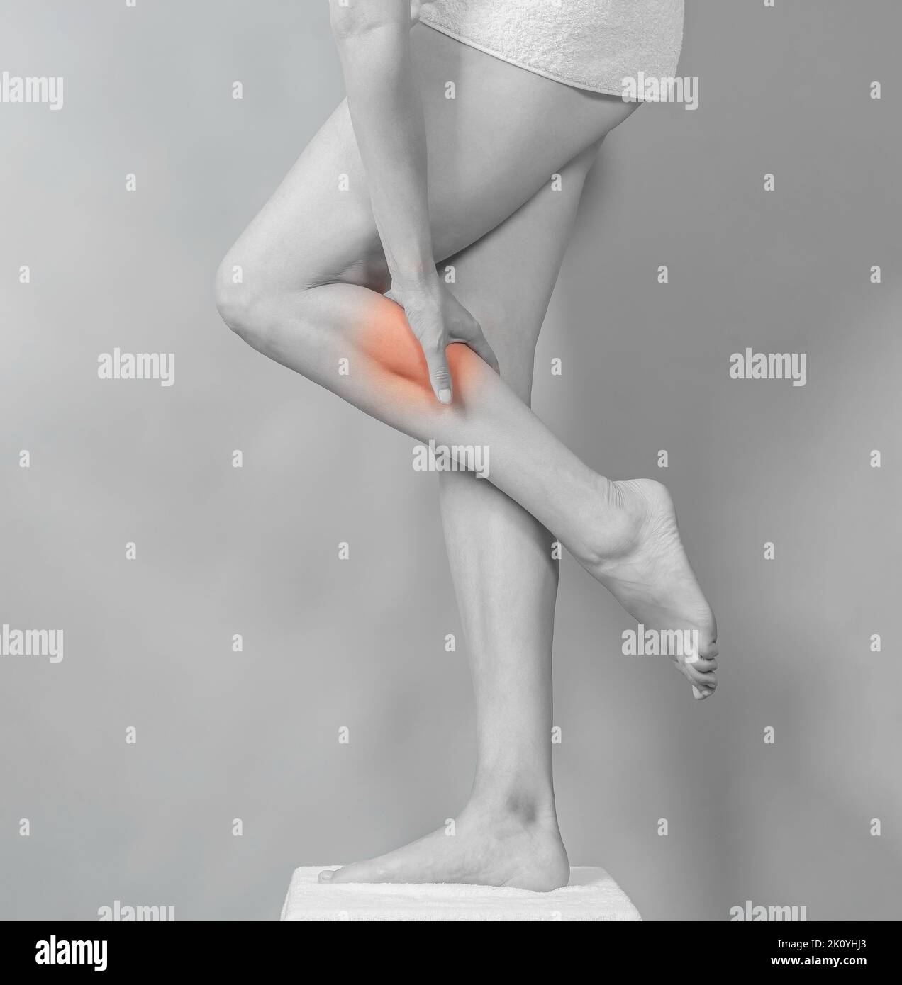 Removal of body hair. A woman touches smooth skin on her legs after ...