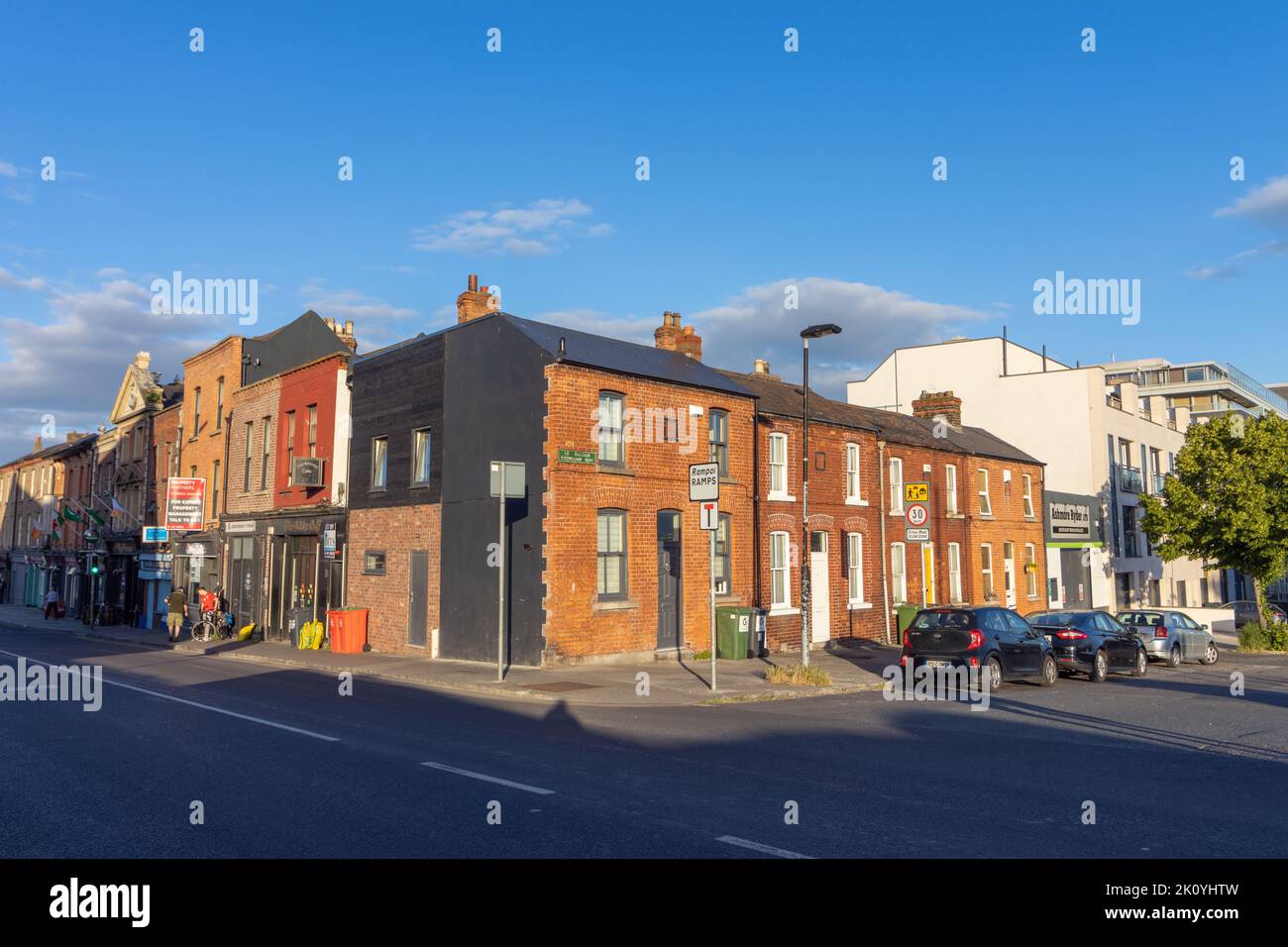 A street corner of picturesque brick buildings with road signs and ...