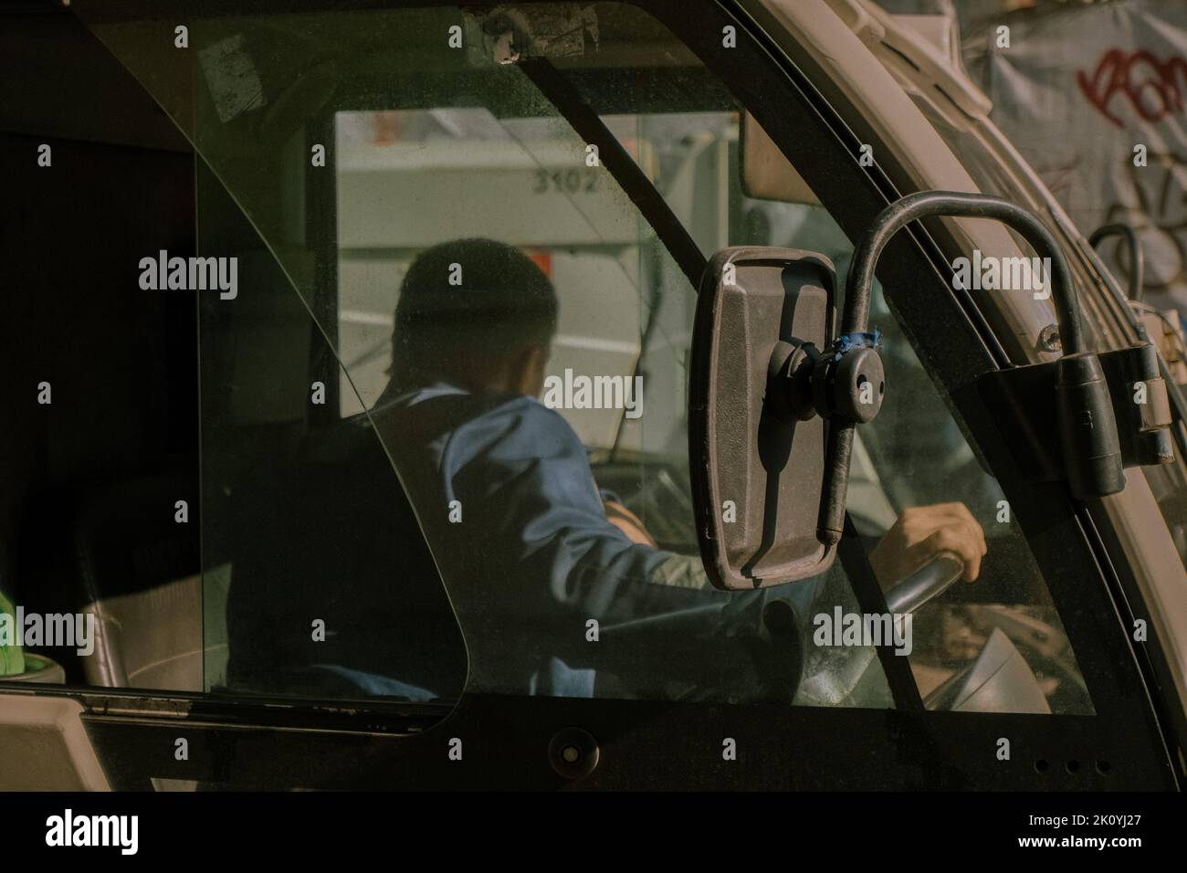A bus driver maneuvering the vehicle Stock Photo - Alamy