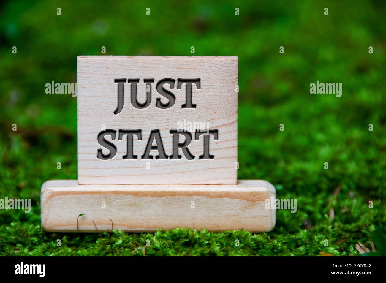 Just start text on wooden block with green nature background ...