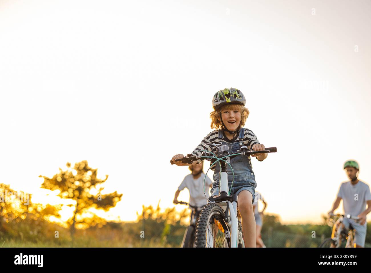 Happy family cycling together in the countryside Stock Photo - Alamy