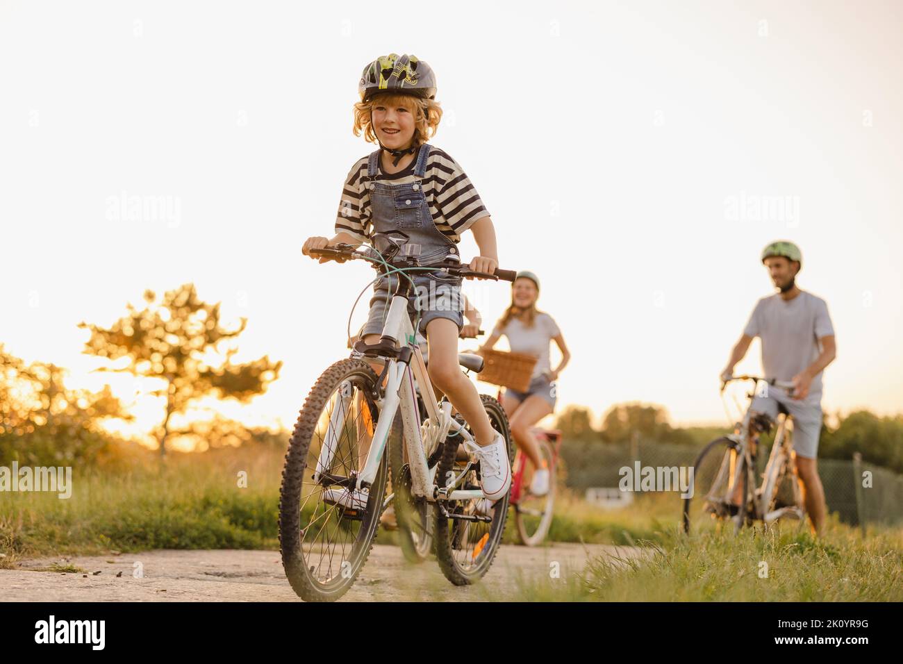 Happy family cycling together in the countryside Stock Photo - Alamy