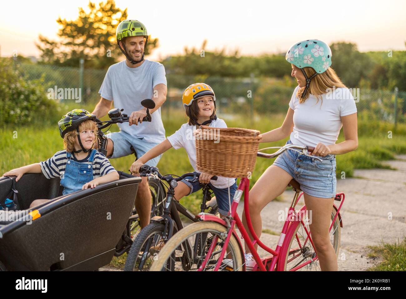 Happy family cycling together in the countryside Stock Photo - Alamy