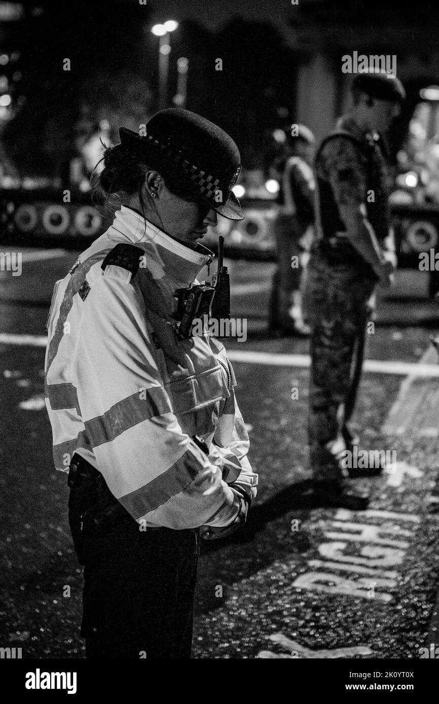 A police officer bows her head as the coffin of Queen Elizabeth II ...