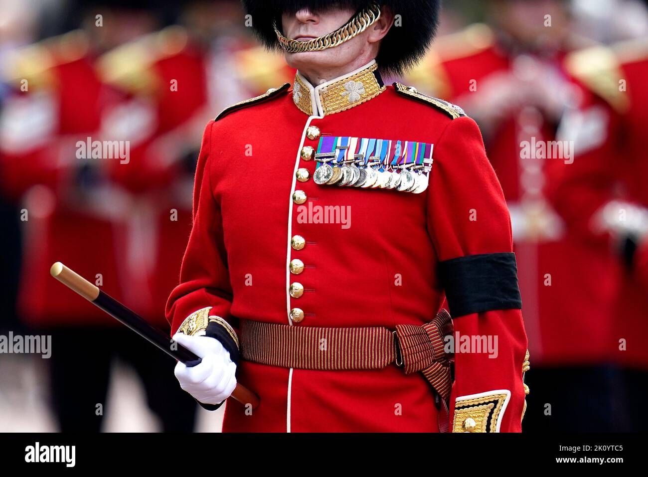 Close up of the black armband on the military procession as the coffin ...