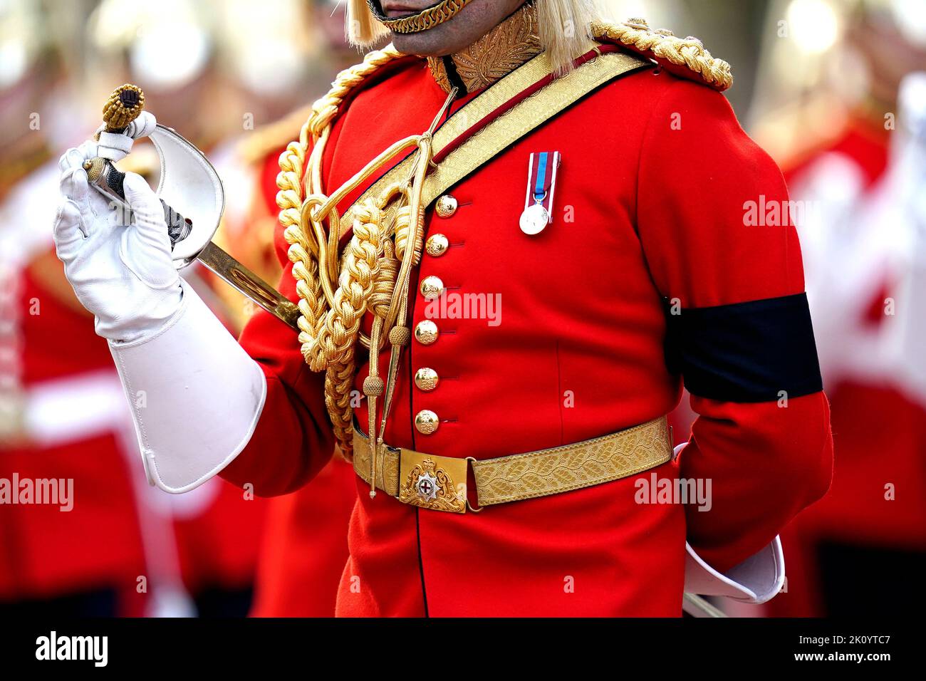 Close up of the black armband on the military procession as the coffin ...