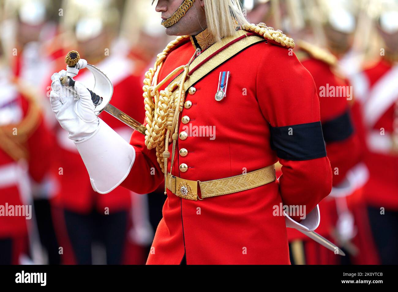 Close up of the black armband on the military procession as the coffin ...
