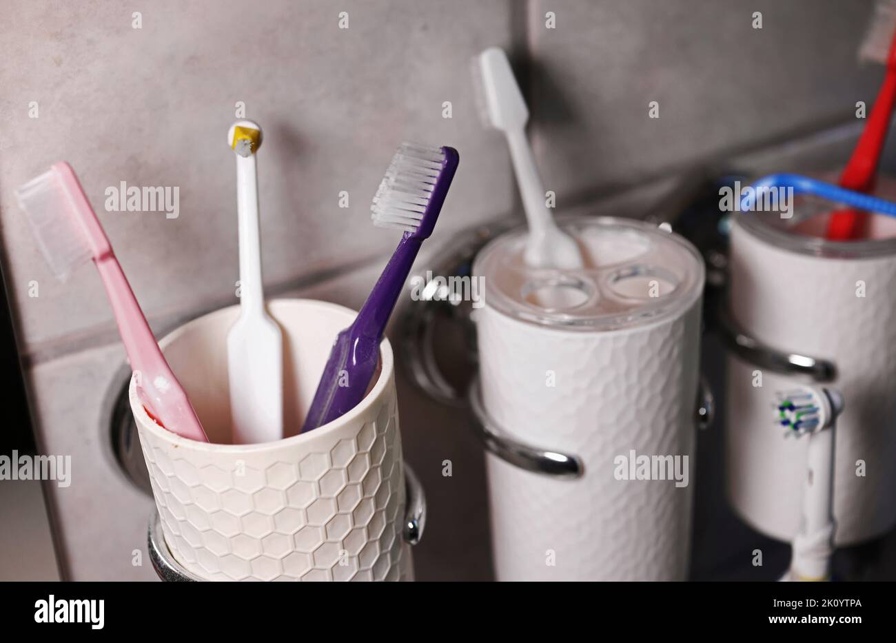 Toothbrushes in a bathroom Stock Photo - Alamy