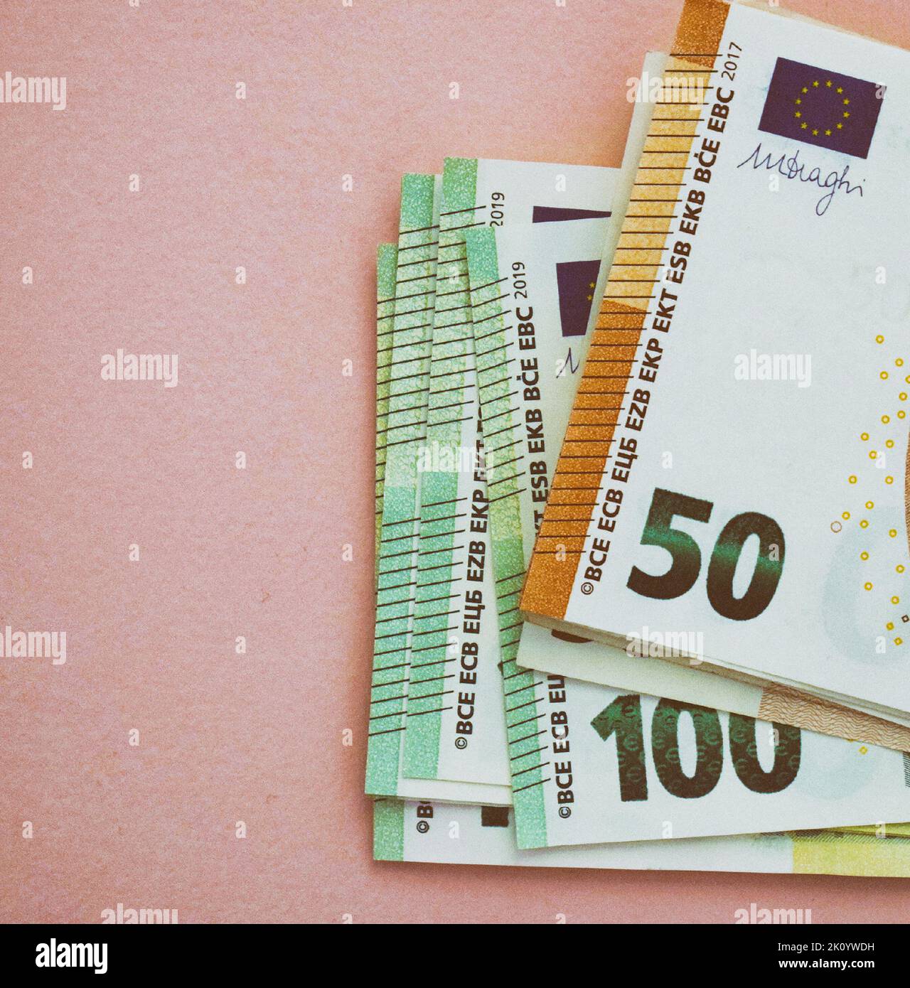 Pack of euro banknotes on pink background. European currency, business ...