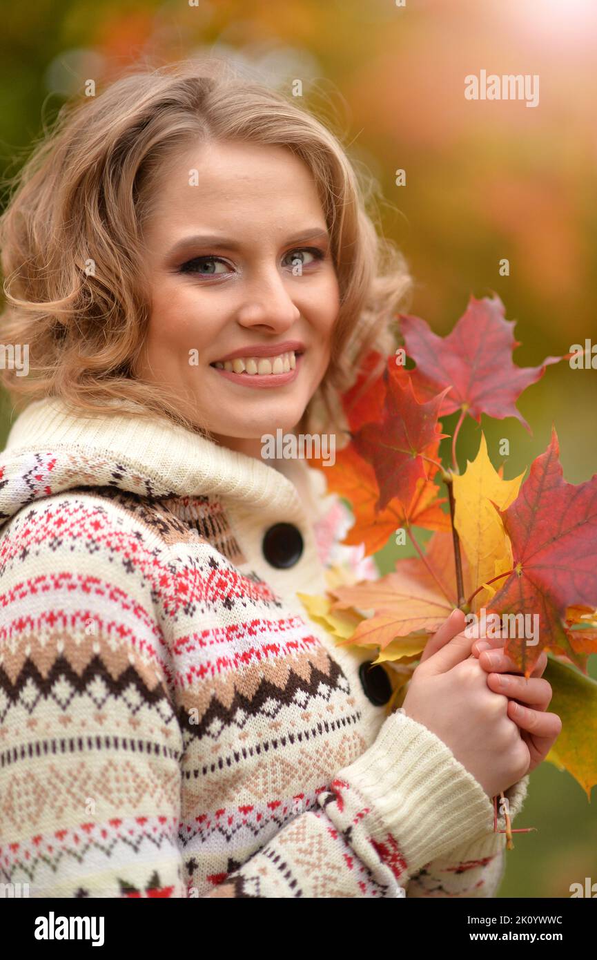 Beautiful woman walking in the park in autumn Stock Photo - Alamy