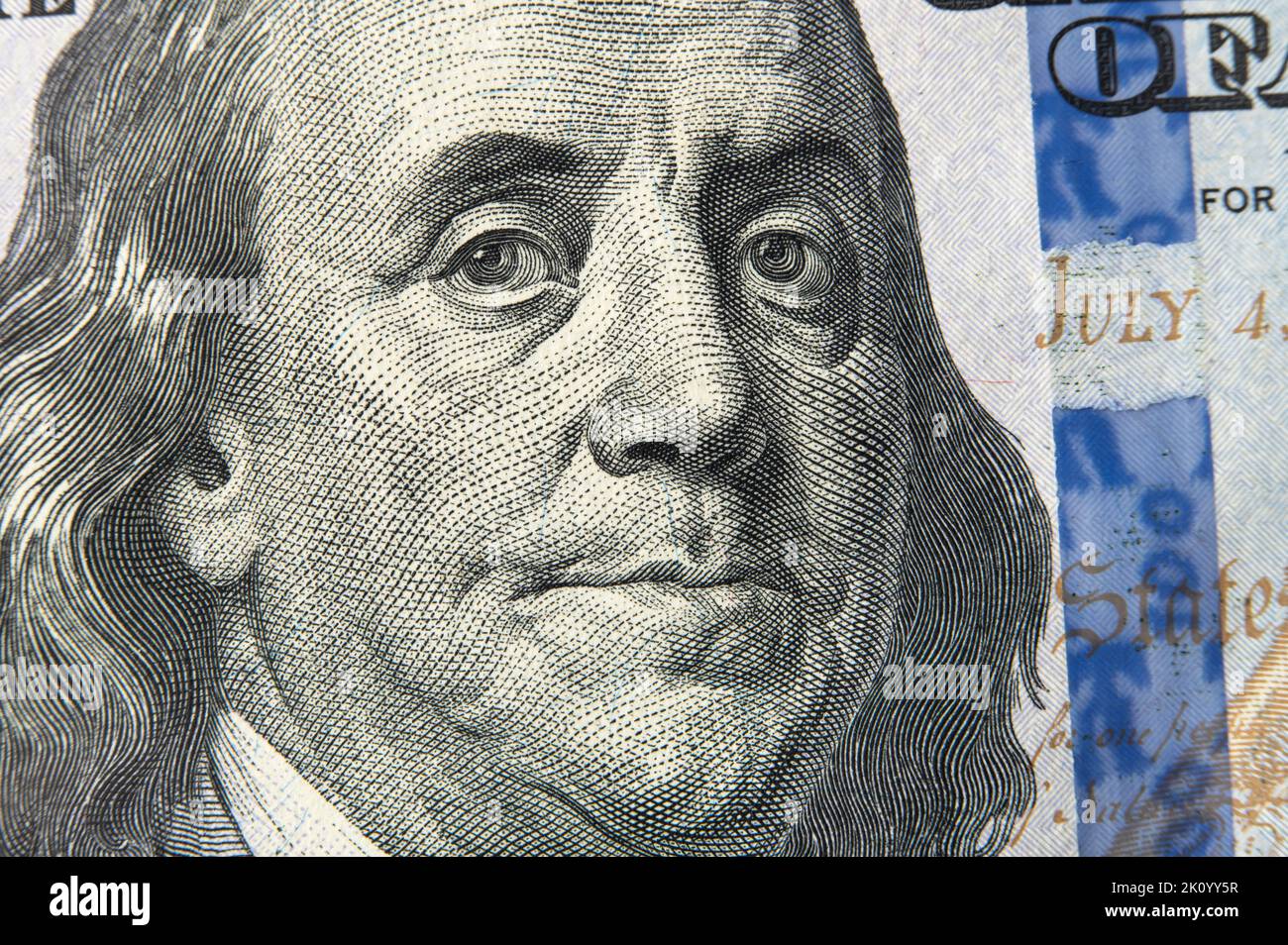 Benjamin Franklin's face on the US 100 dollar bill. Closeup of Ben Franklin on a one hundred ...