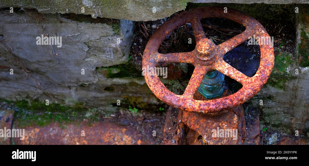 Old rusted and broken iron water pipe with valve turn wheel rust Stock ...