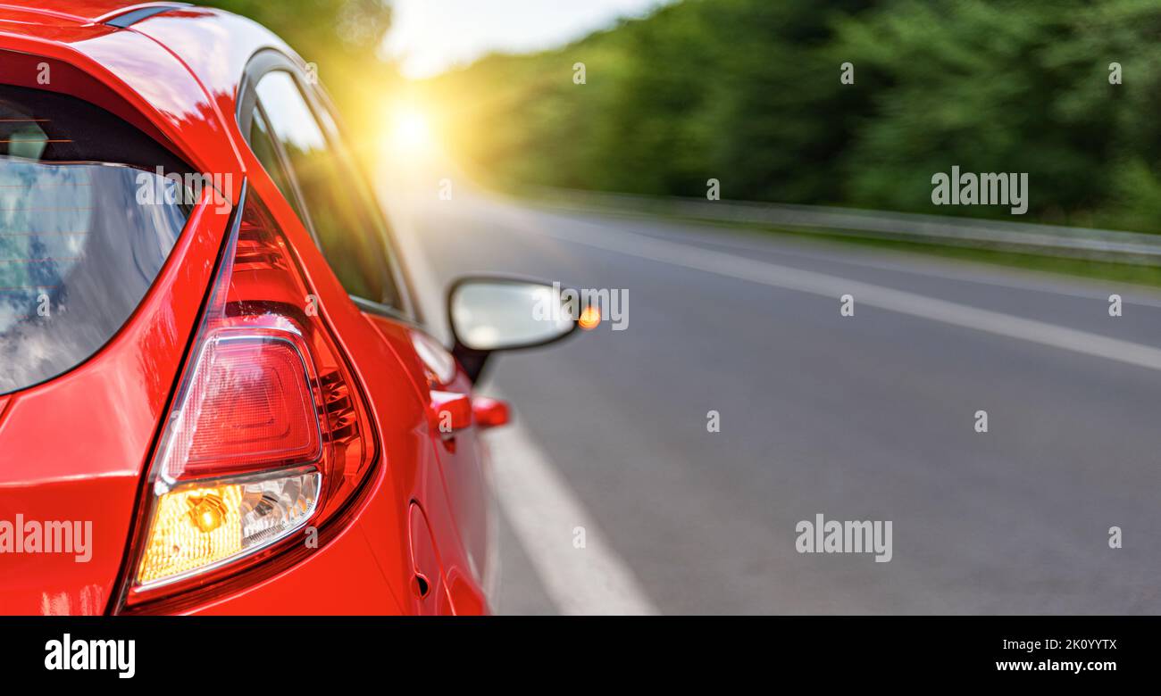 Red car on the road Stock Photo - Alamy