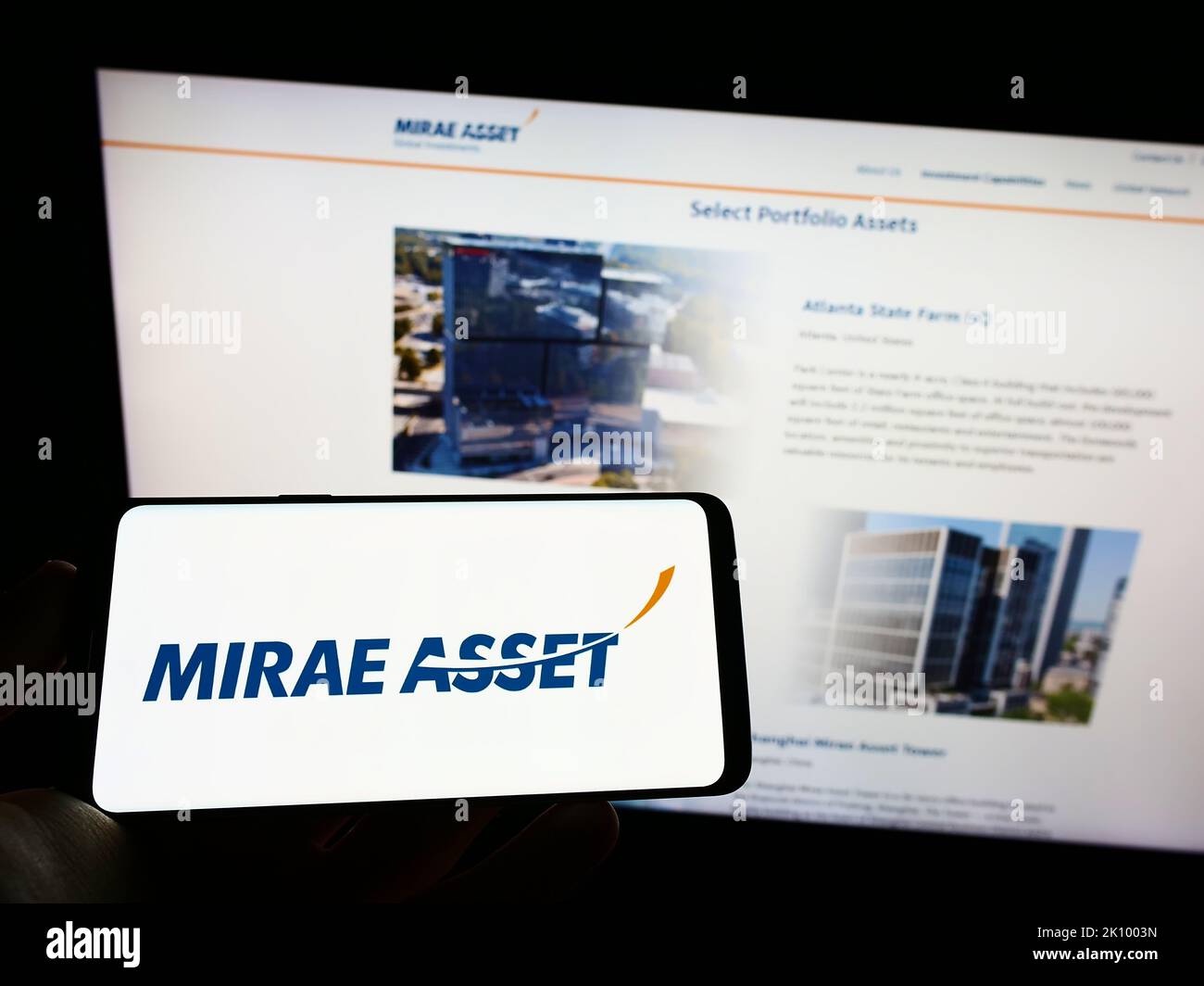 Person holding mobile phone with logo of South Korean company Mirae ...