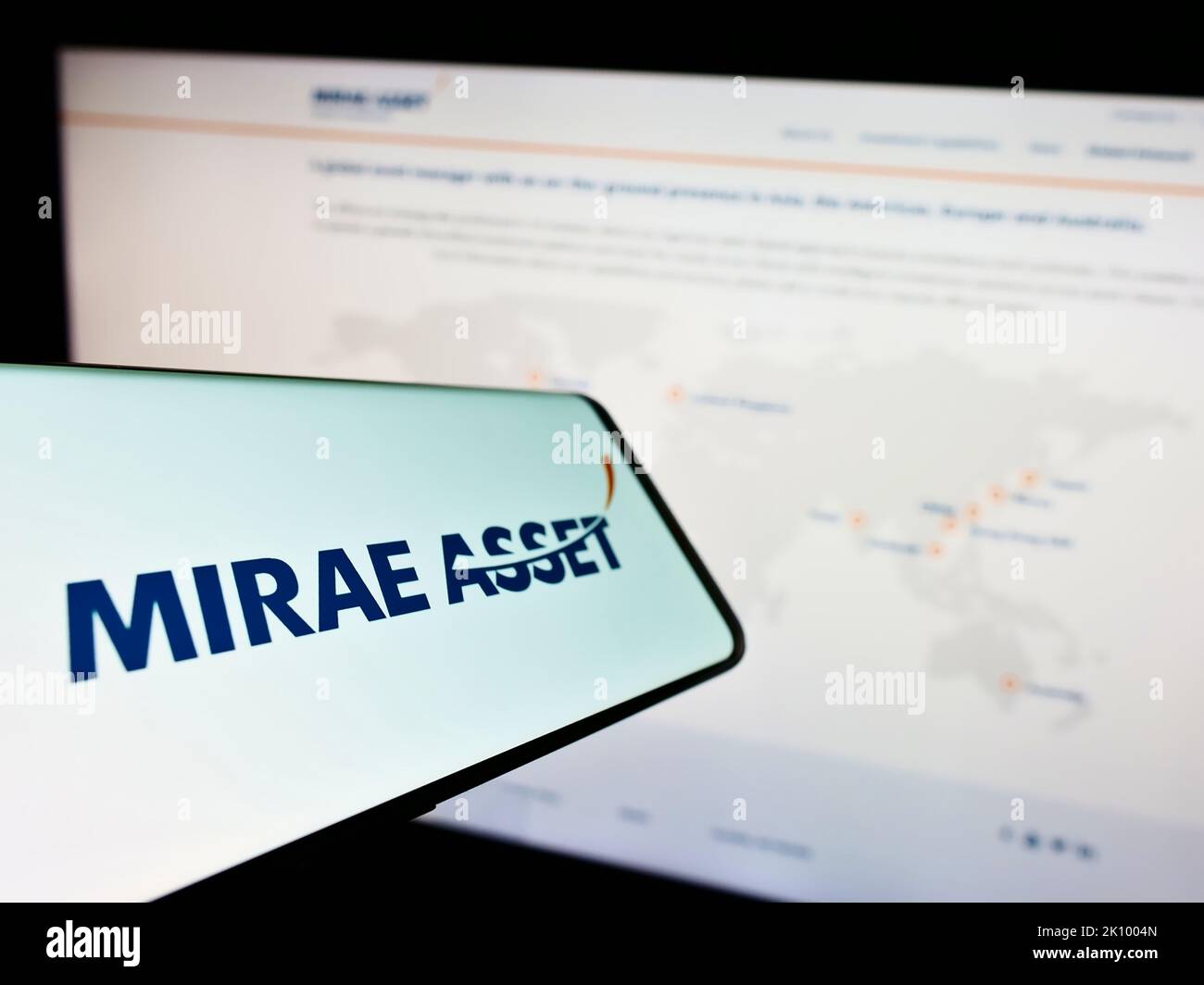 Mobile phone with logo of South Korean company Mirae Asset Financial Group on screen in front of ...