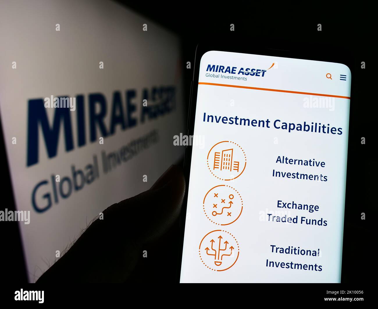 Person holding cellphone with webpage of South Korean company Mirae Asset Financial Group on ...