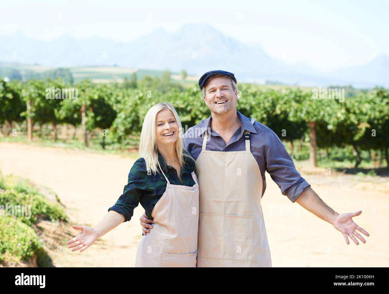 Welcome to our farm. A married couple standing proudly in front of ...