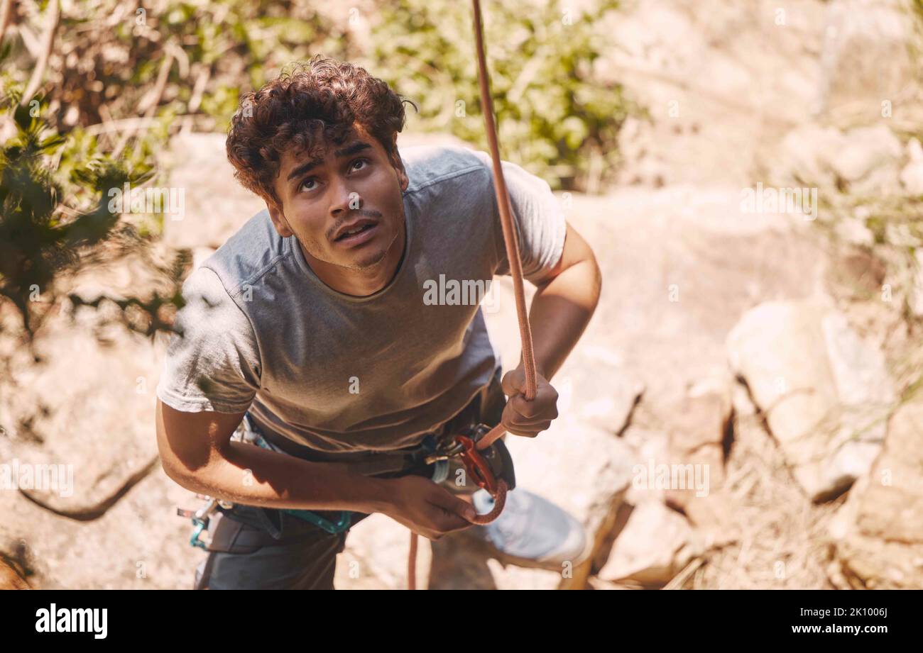 Man on rock in nature, climbing mountain with with safety equipment and ...