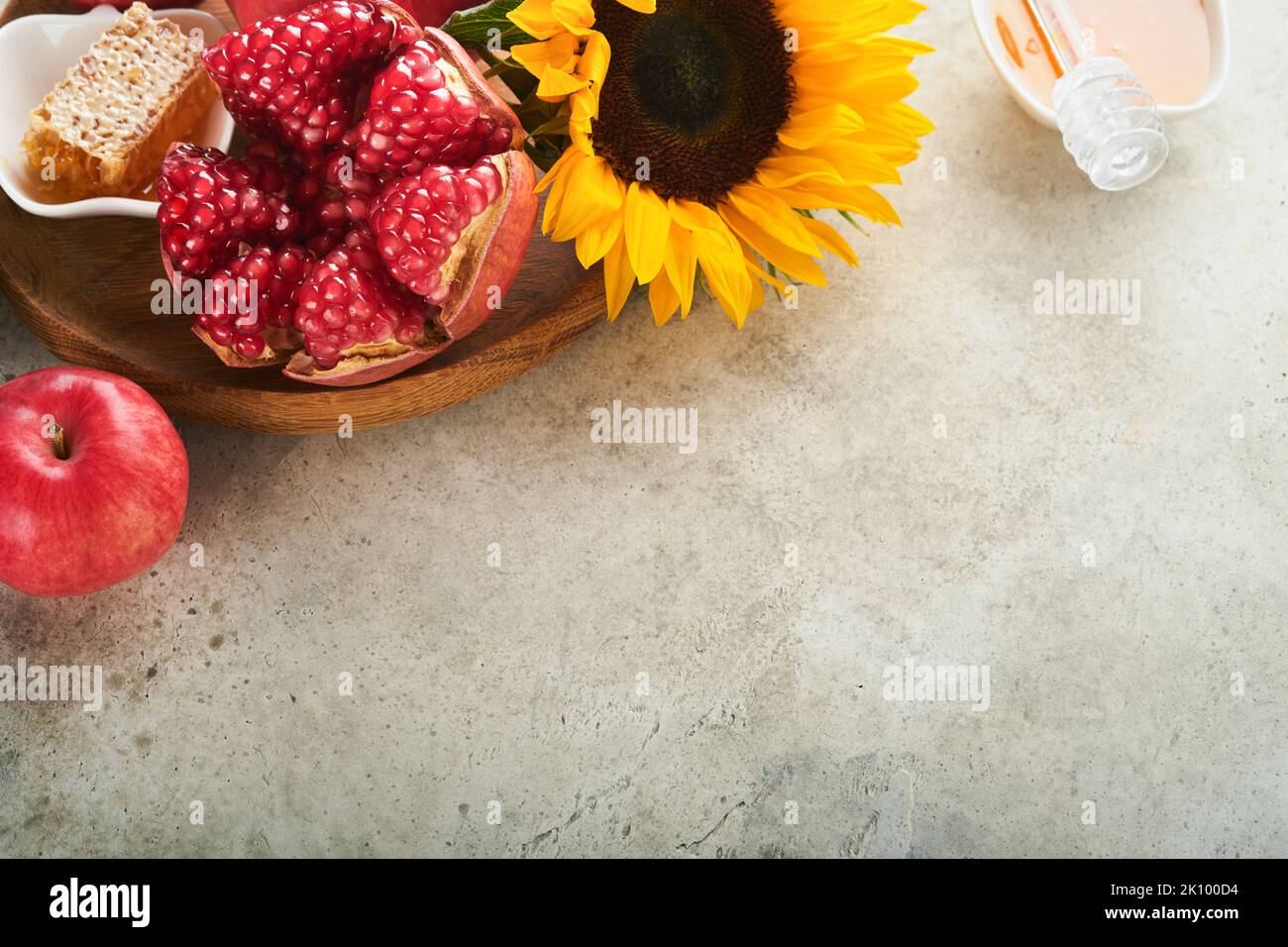 Rosh Hashanah. Ripe pomegranate, apple, honey and sunflower, yellow ...