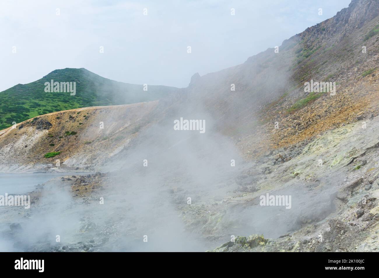 steaming hydrothermal outlet on the shore of the hot lake in the ...