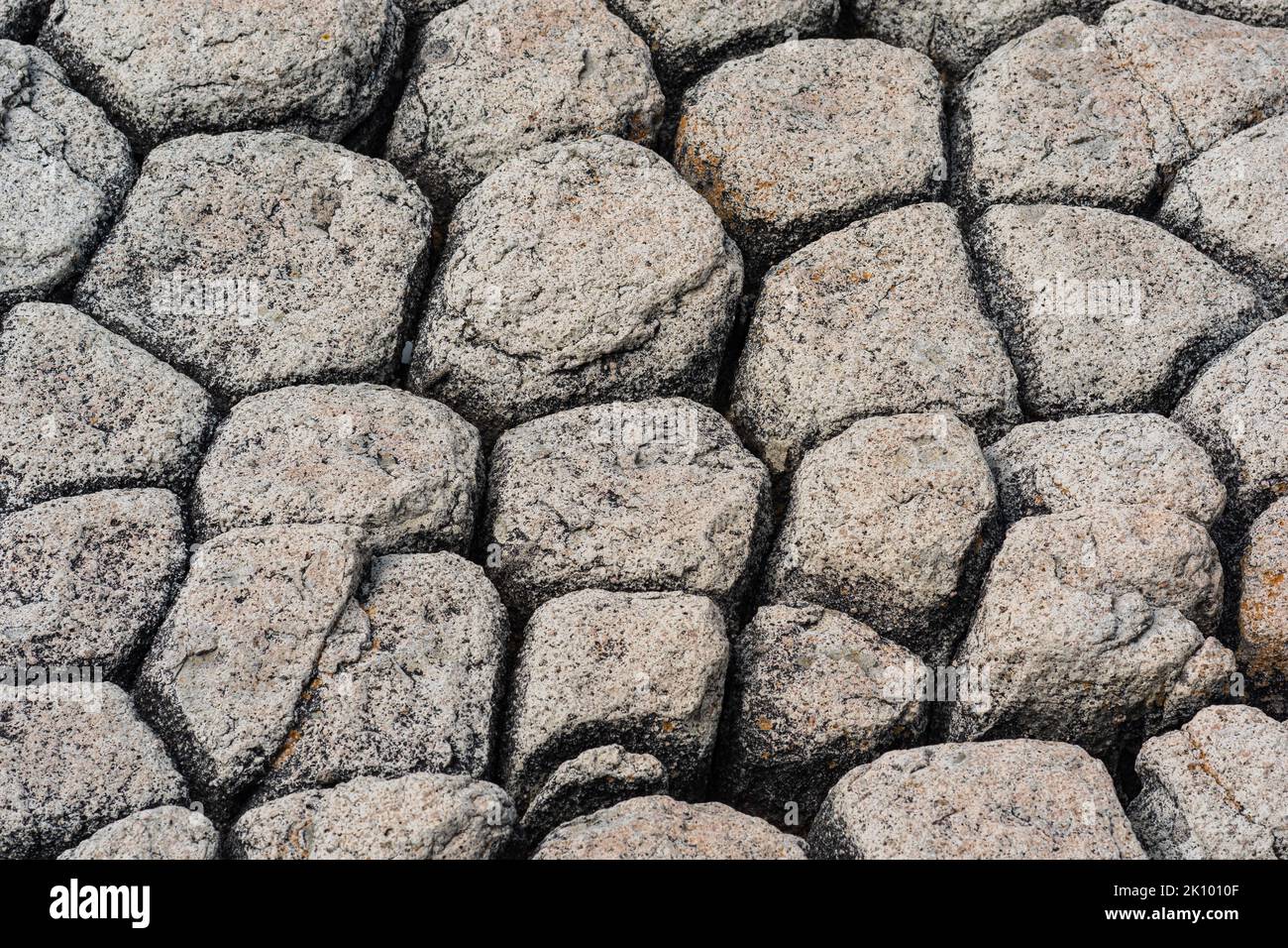 natural stone background, the remains of lava basalt columns form a ...