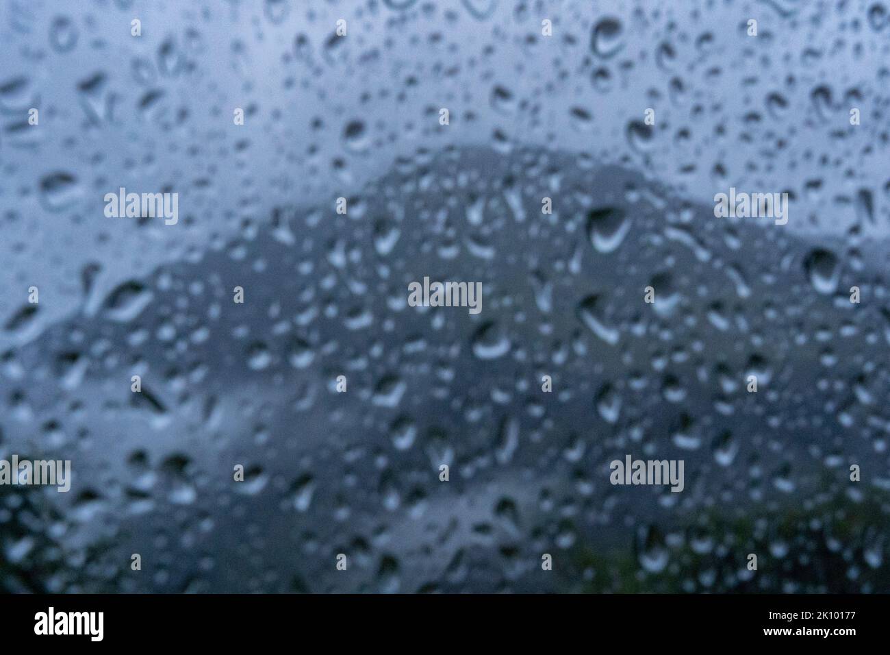 raindrops on window with mountain in background at ann tor, glen coe ...