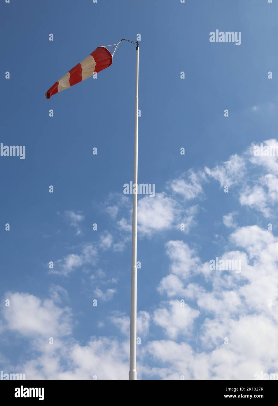 red and white windsock to indicate the direction of the air flow and ...