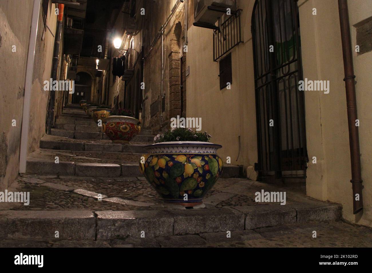 alley and ceramic flower pot in cefalu in sicily (italy Stock Photo - Alamy
