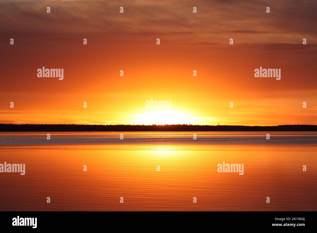 Sunset on glass lake Sunset Point, Alberta Stock Photo - Alamy