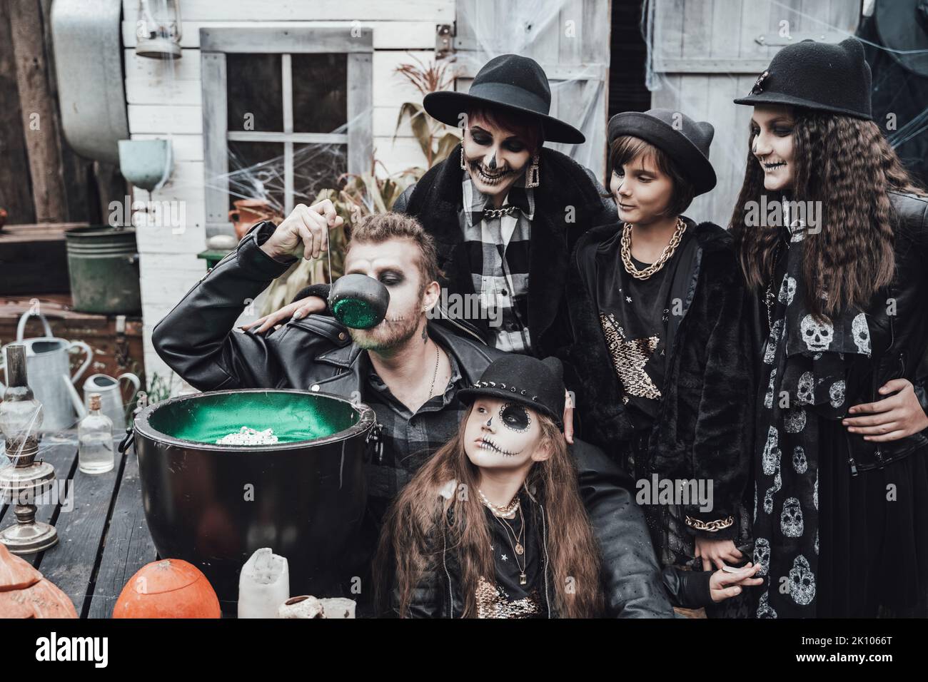 Scary family, mother, father, daughters celebrating halloween. Cauldron ...