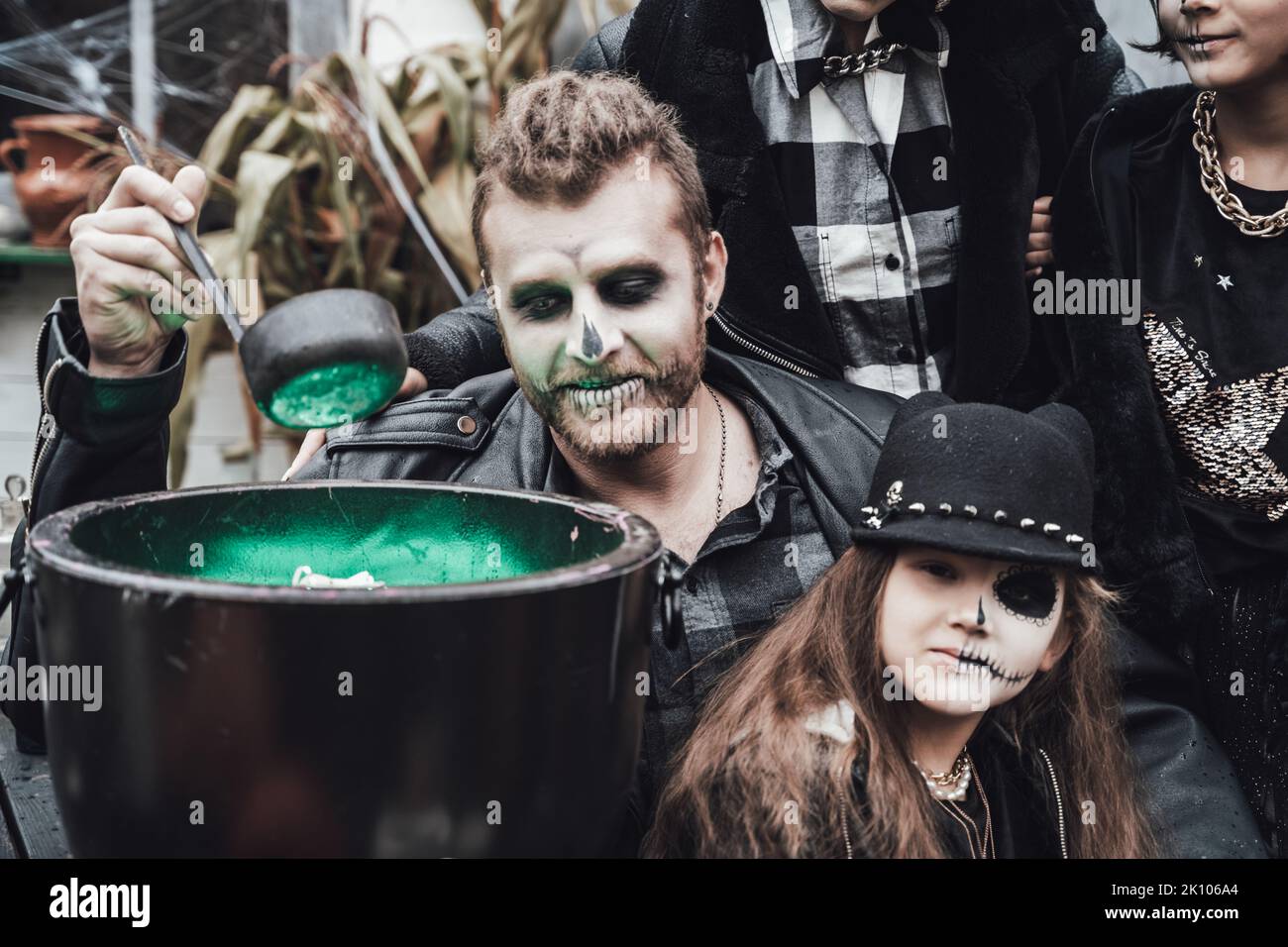 Scary family, mother, father, daughters celebrating halloween. Cauldron ...