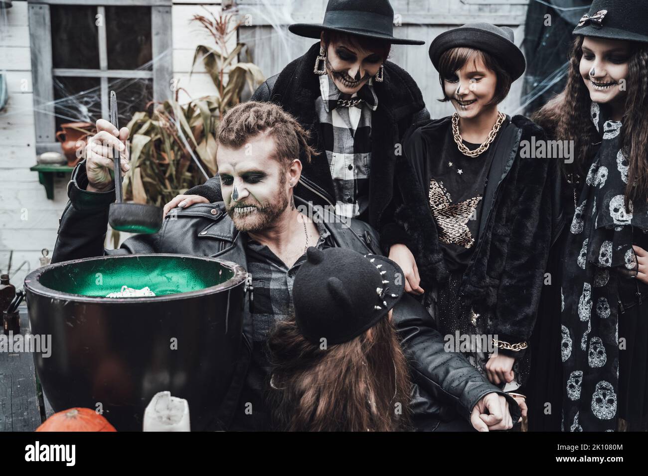Scary family, mother, father, daughters celebrating halloween. Cauldron ...