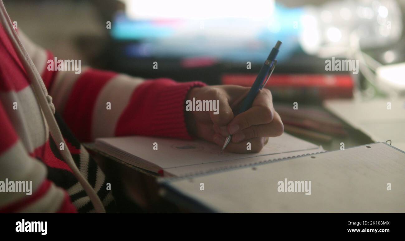 Female student woking at night, woman studying taking notes Stock Photo ...