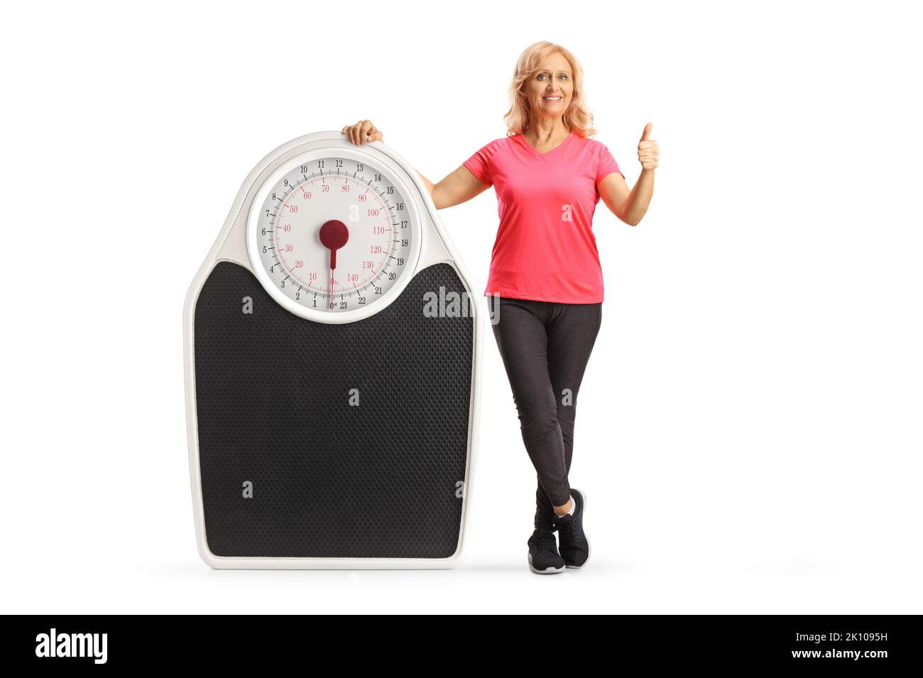 Full length portrait of a mature woman in sportswear posing with a big ...