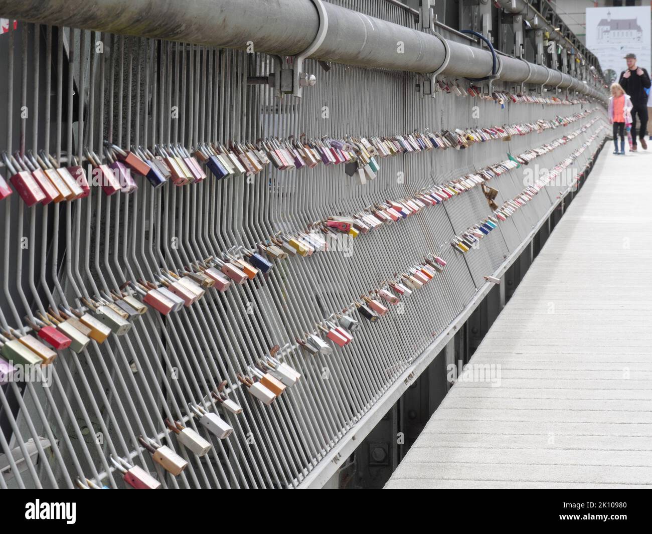 Colorful padlocks hang on the parapet of a bridge as a symbol of the ...