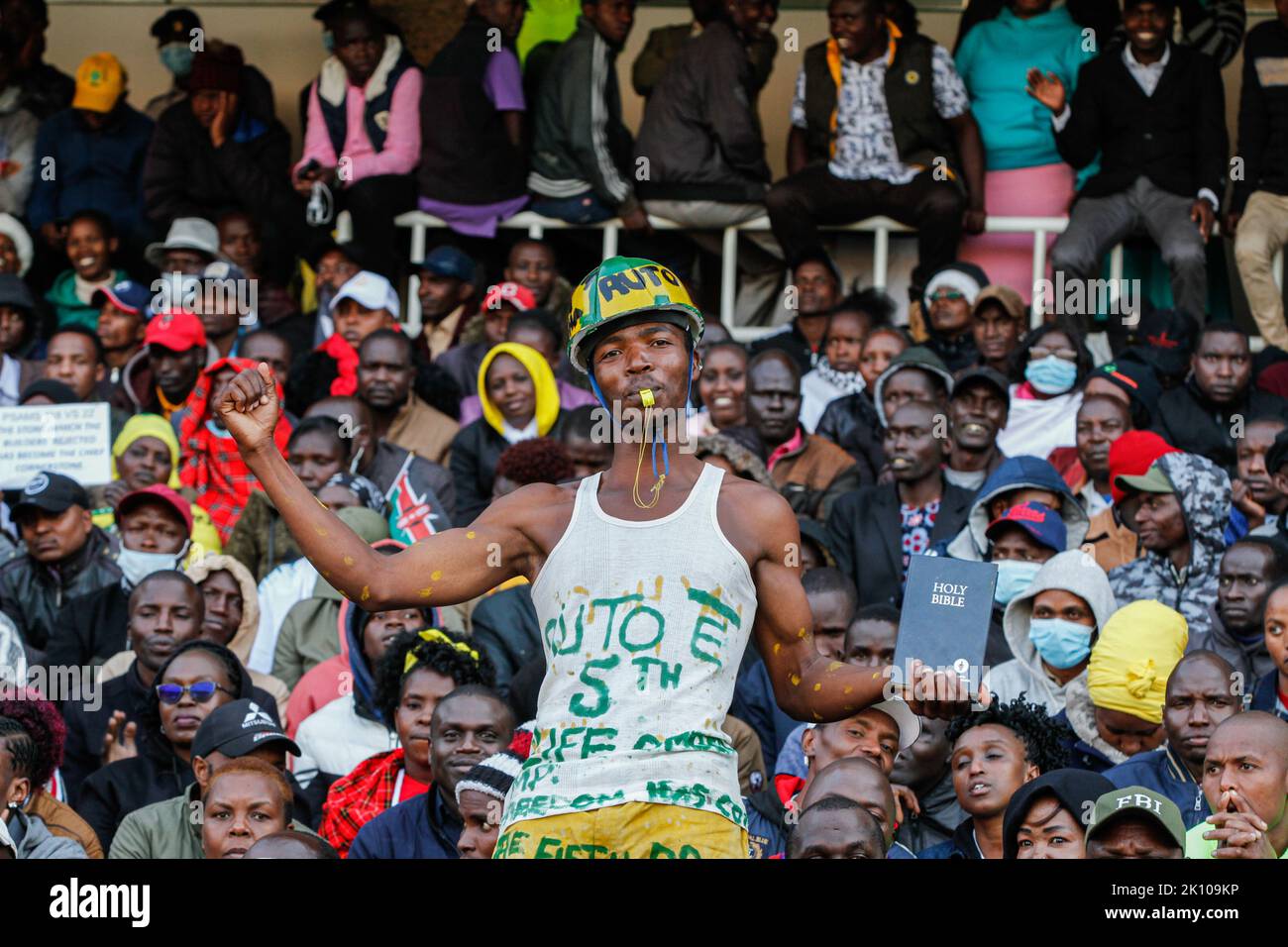A Kenyan man (C) displays a bible and clenches his fist as a sign of freedom, at the Moi ...