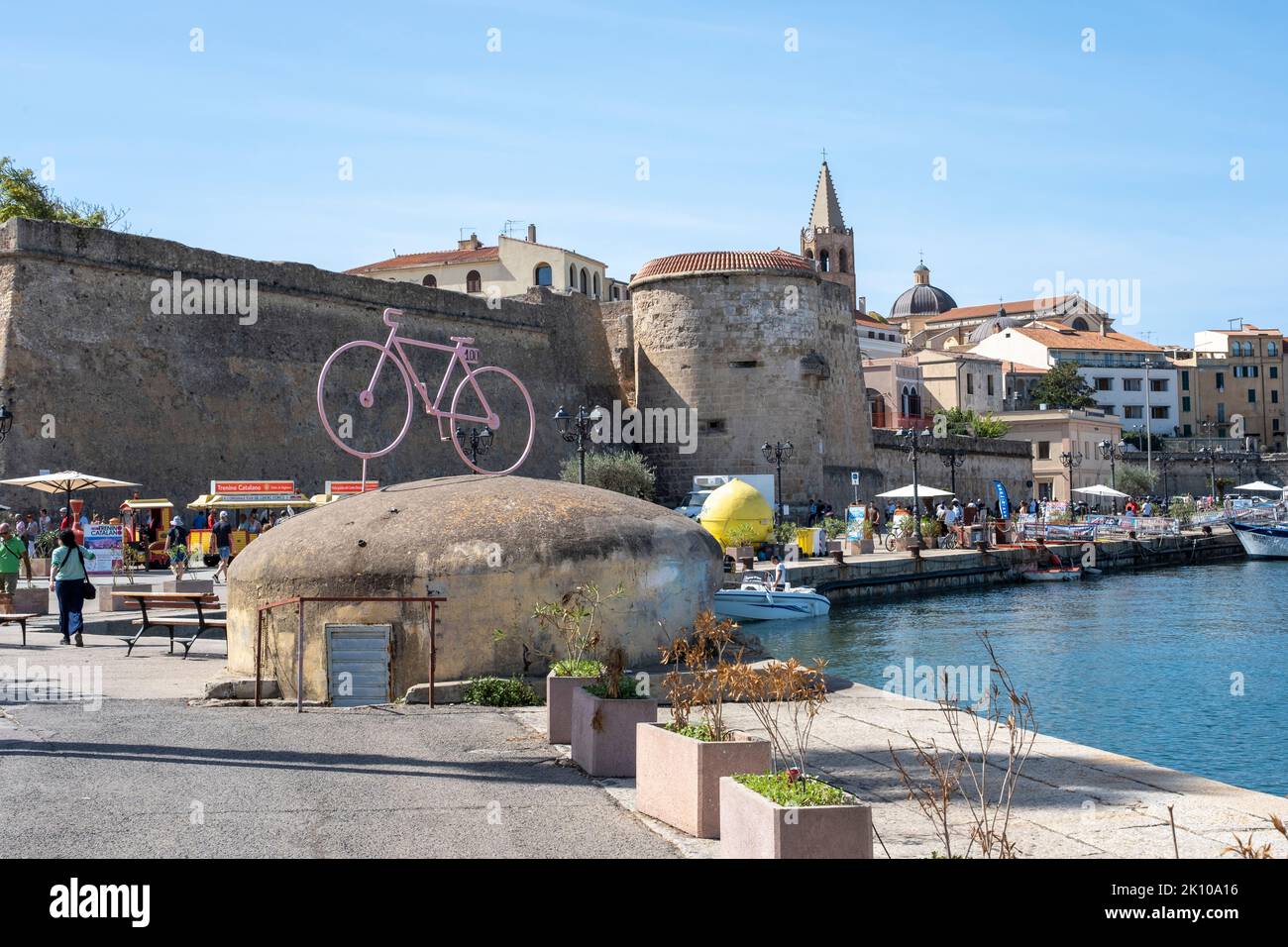 Pink racing bicycle statue with view of the old town citadel and ...