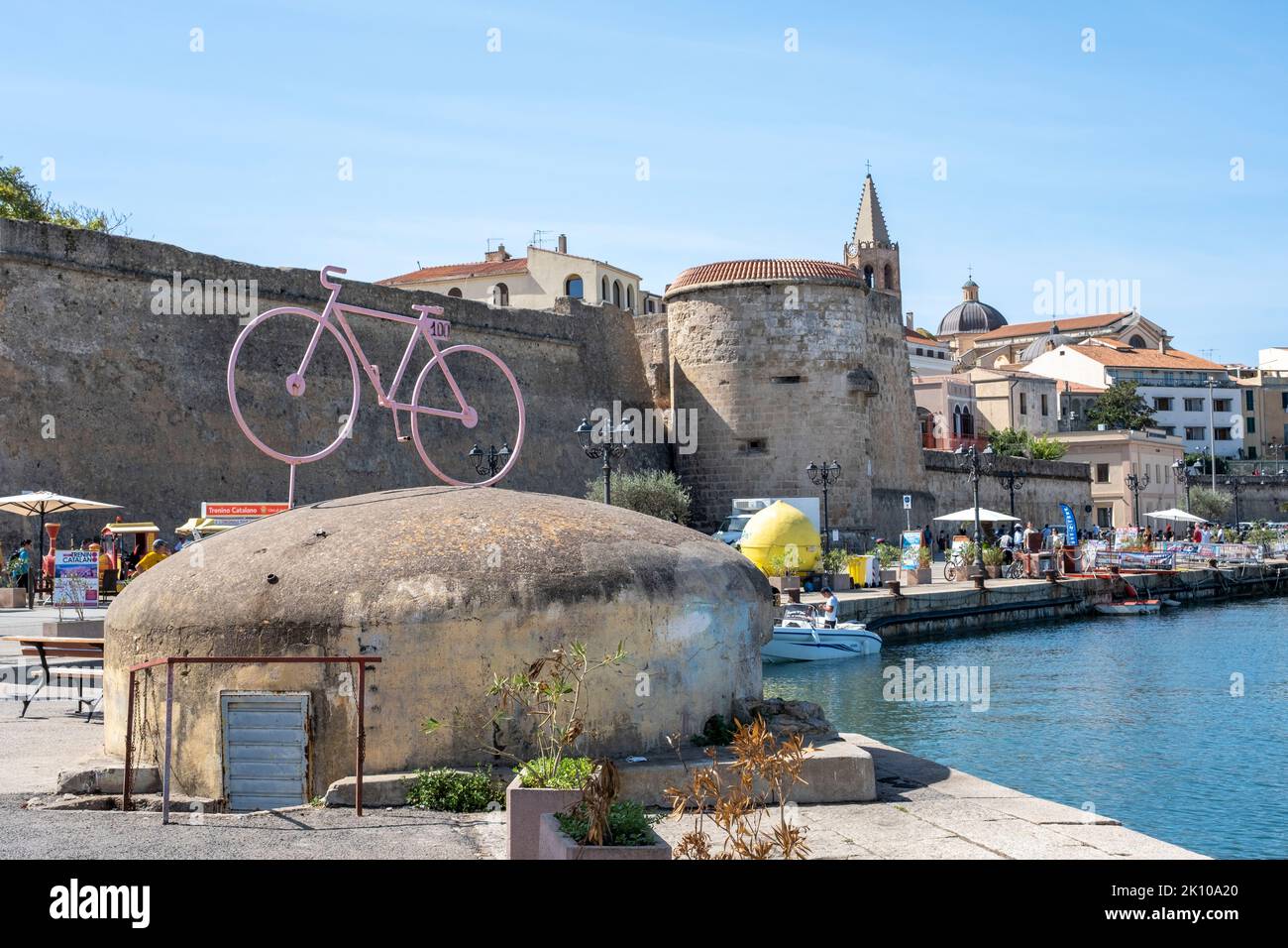 Pink racing bicycle statue with view of the old town citadel and ...