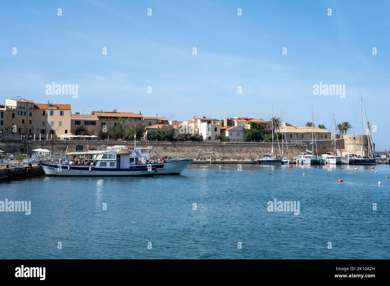 View Of The Old Town Citadel And Harbour From The Port Of Alghero Sardinia Italy With Neptune