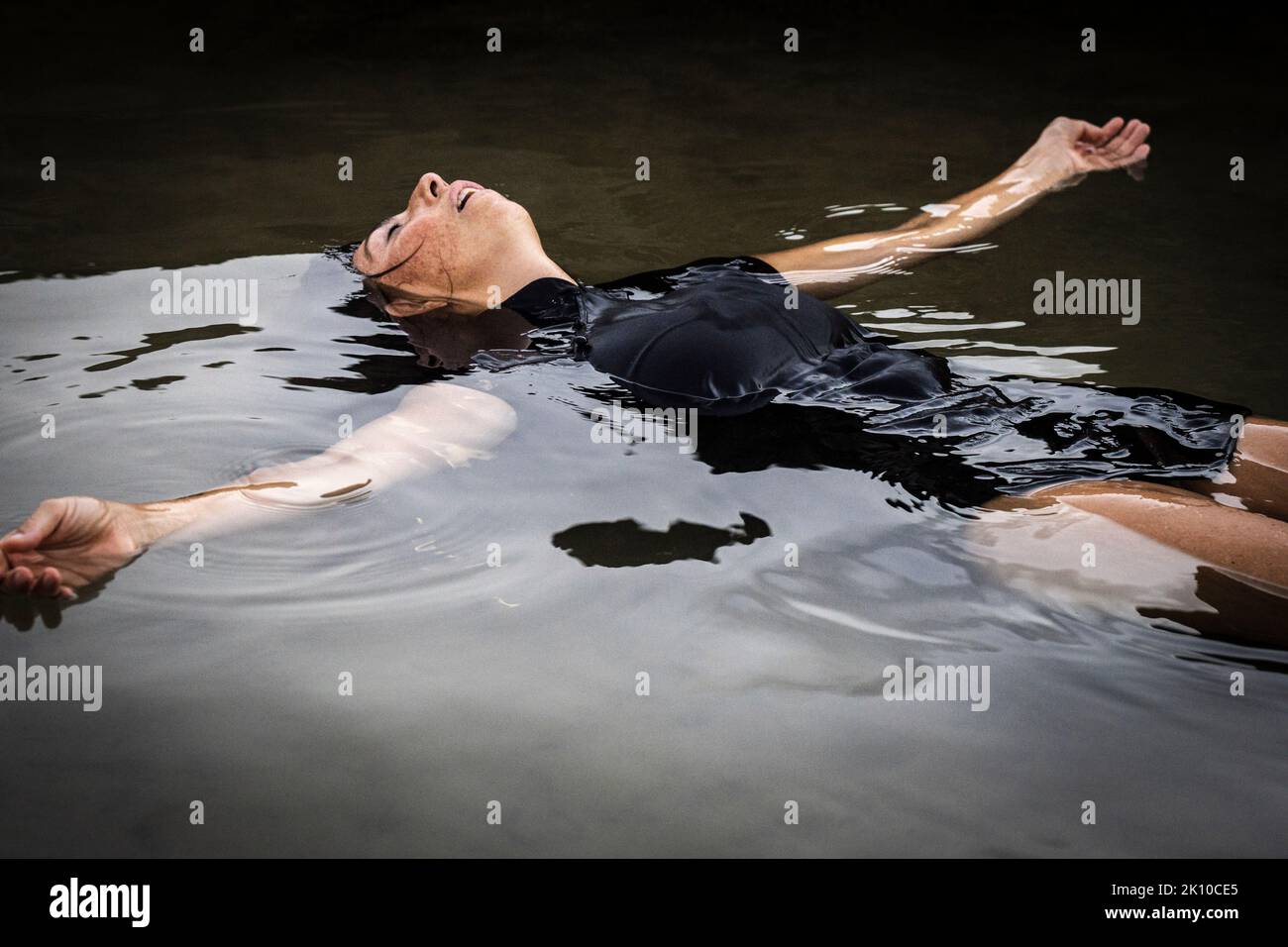 middle-aged woman dancing and throwing water in the air, Maioris beach ...