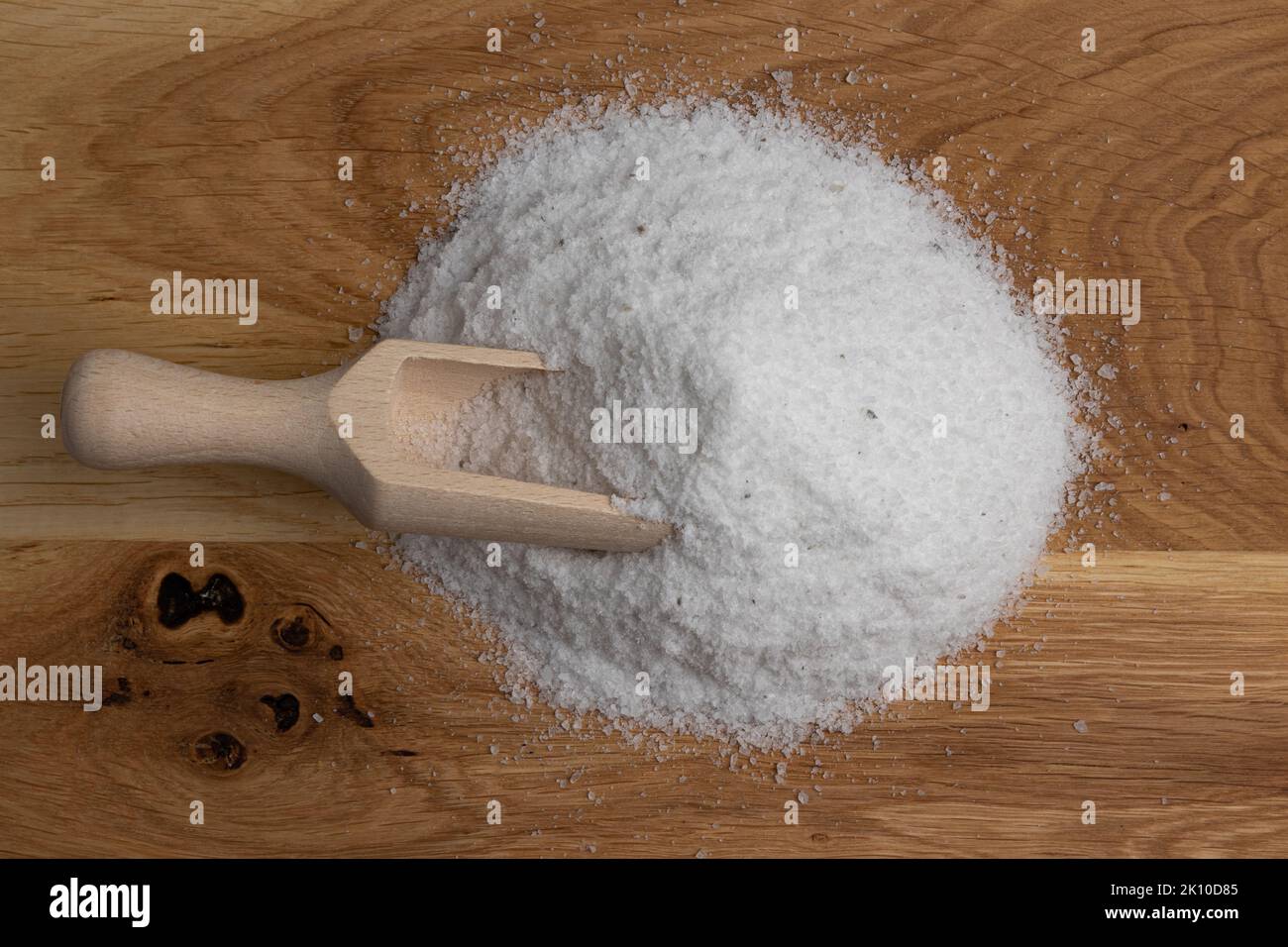 pile of kitchen salt, mineral sea salt in wooden scoop isolated on ...