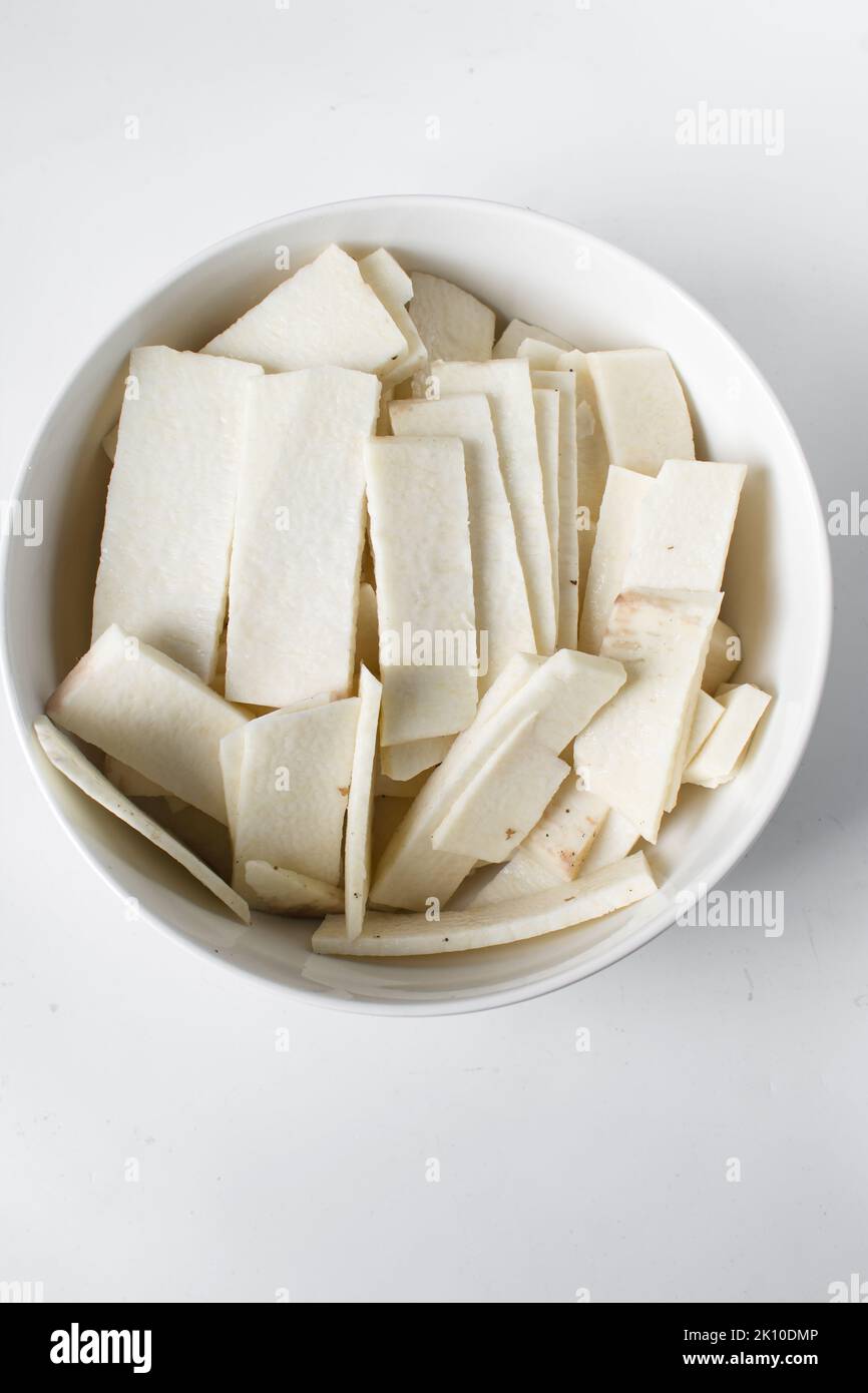 Raw yam in a white bowl, slices of raw yam, fried yam slices, nigerian ...