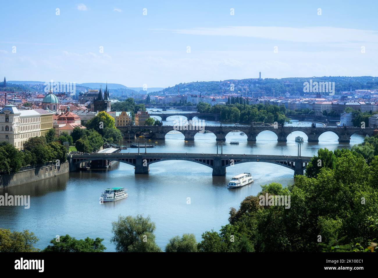 View of the bridges on the Vlatva River in the Czech city of Prague from the Summer Gardens ...