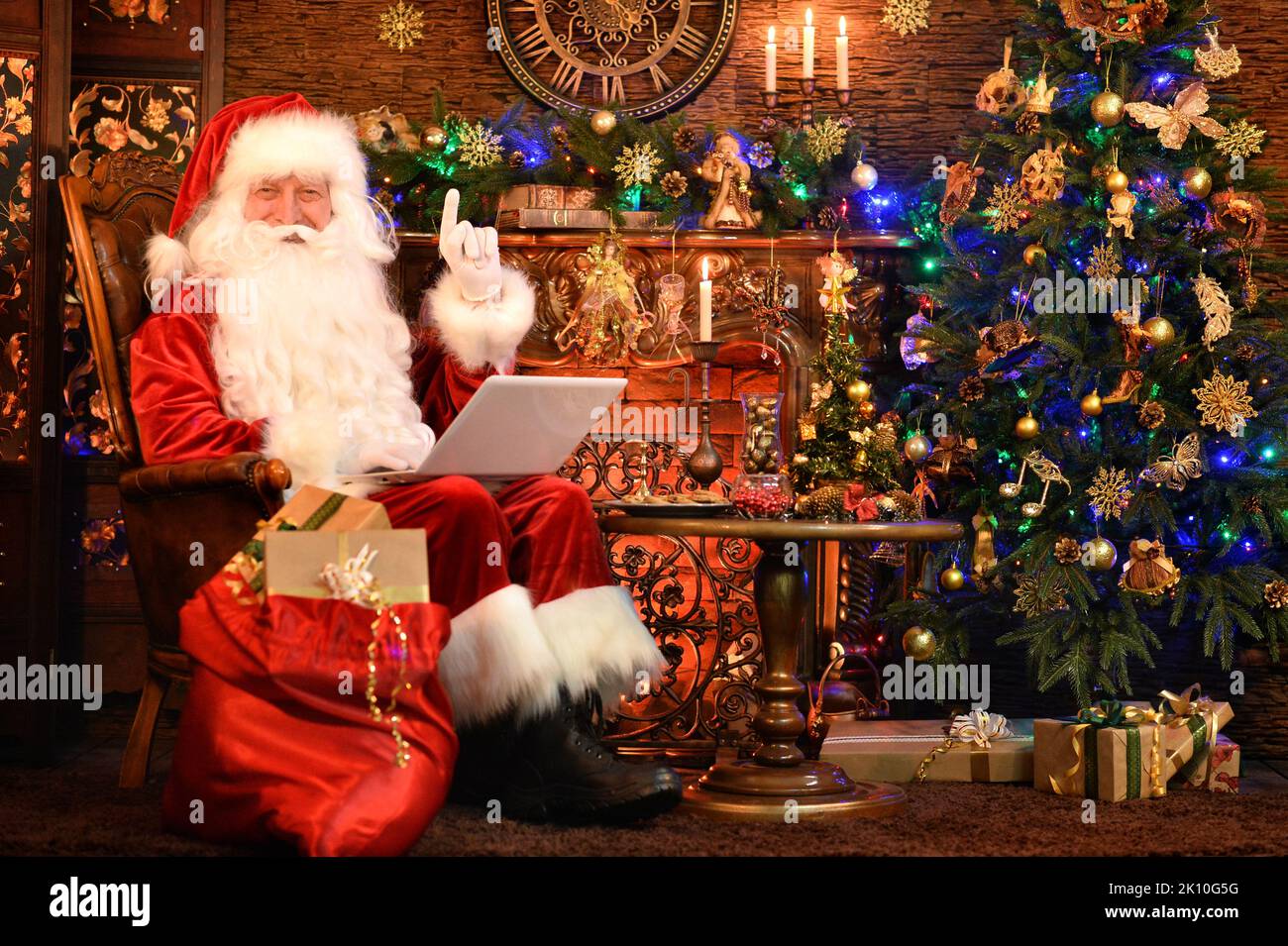 Santa Claus in a traditional costume with a bag of gifts Stock Photo ...