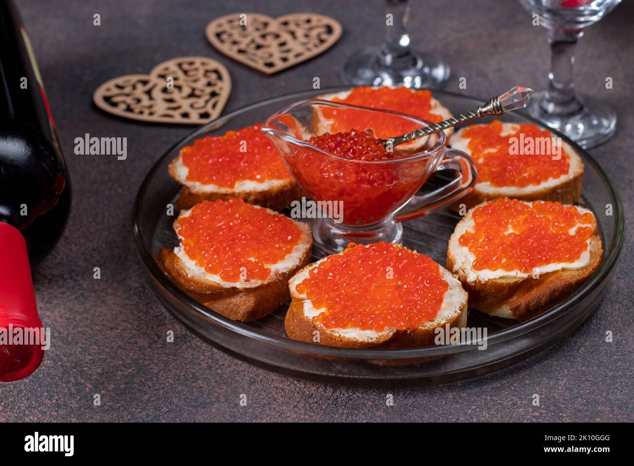 Sandwiches with red caviar on white bread toasts on round plate on ...