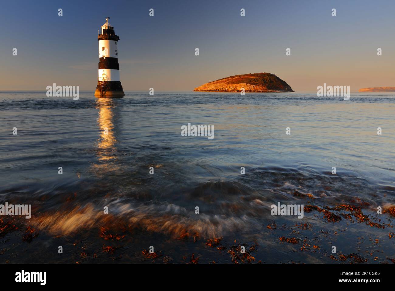 Penmon Lighthouse and Puffin Island on a calm summer evening. Anglesey ...