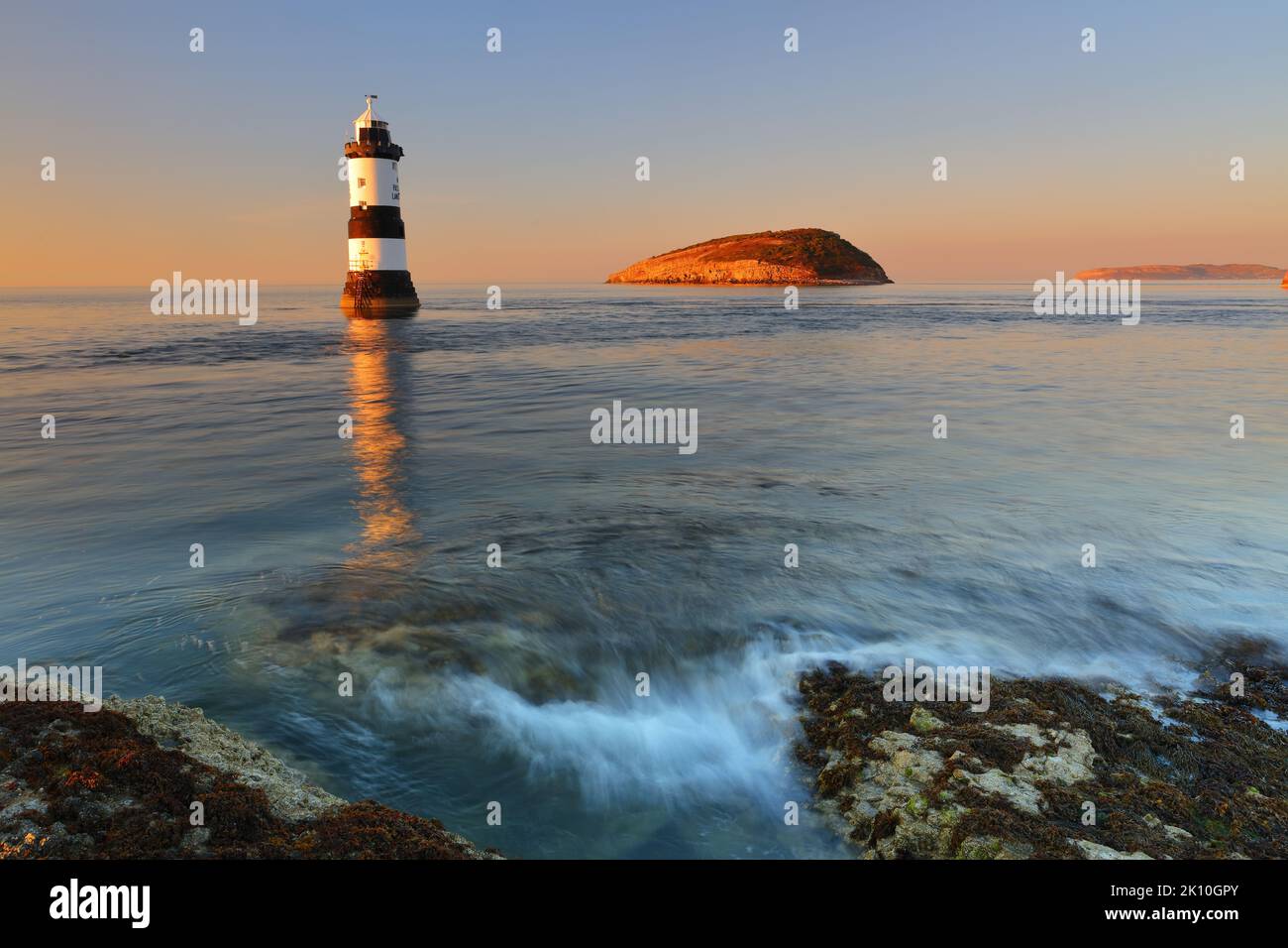 Penmon Point Lighthouse at Sunset with Puffin Island in the background ...