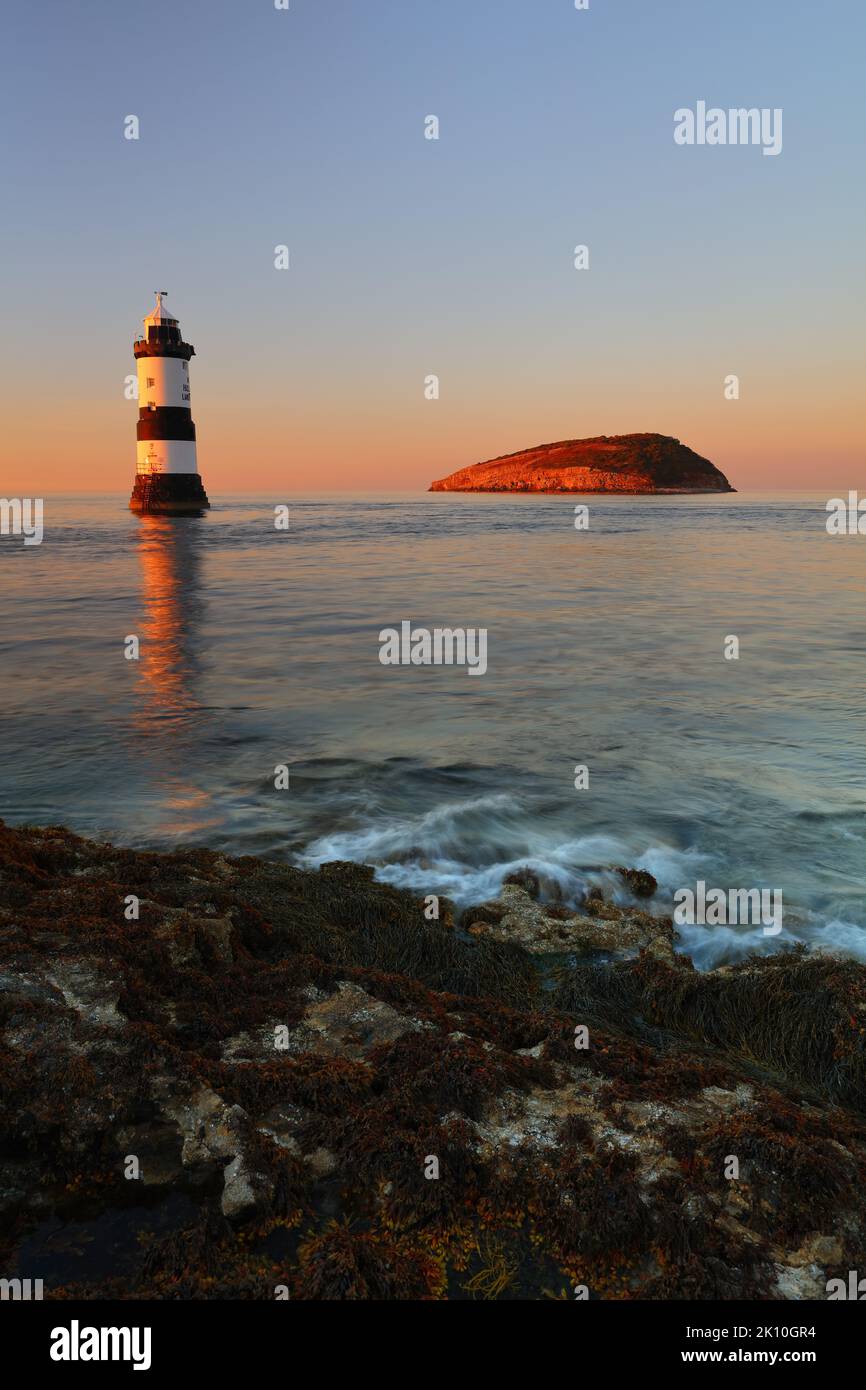 Penmon Point Lighthouse at Sunset with Puffin Island in the background ...